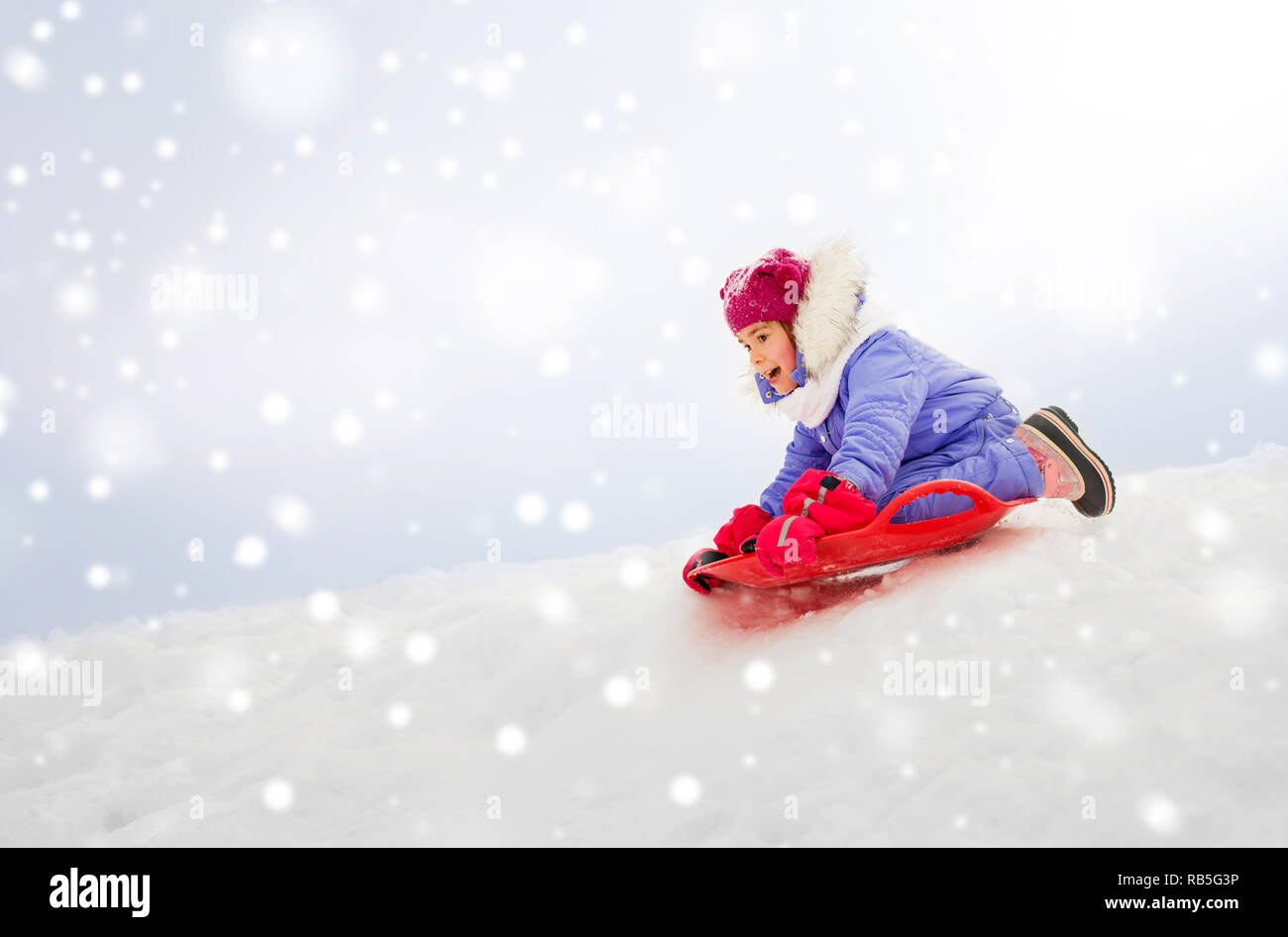 Child girl people person riding sledge sliding snow hi-res stock ...
