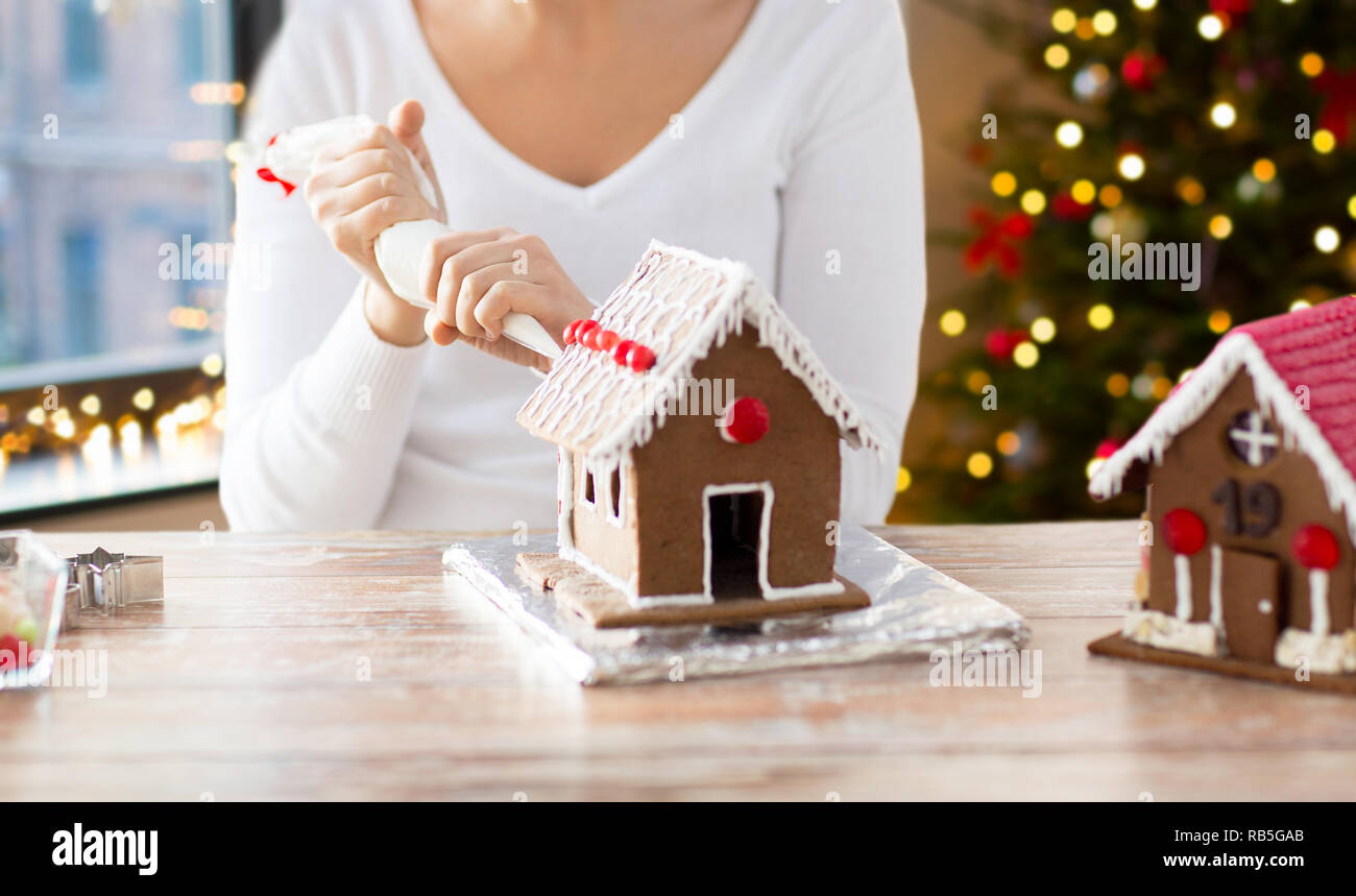 woman making gingerbread houses on christmas Stock Photo - Alamy
