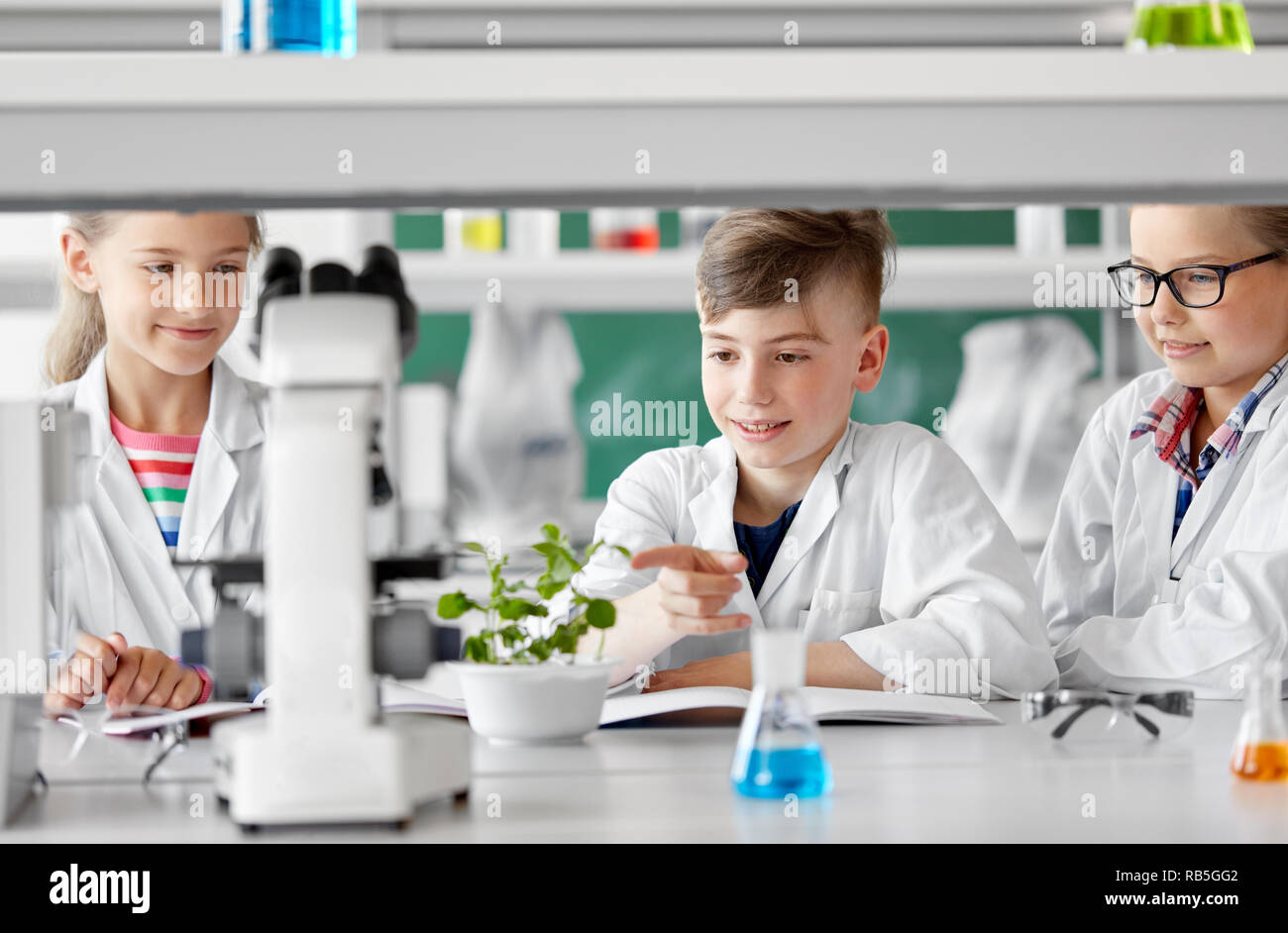 kids or students with plant at biology class Stock Photo - Alamy