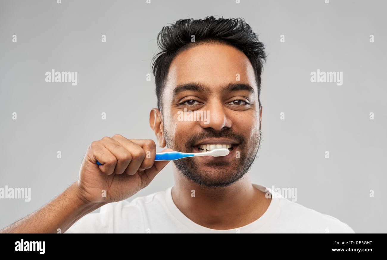 indian man with toothbrush cleaning teeth Stock Photo - Alamy
