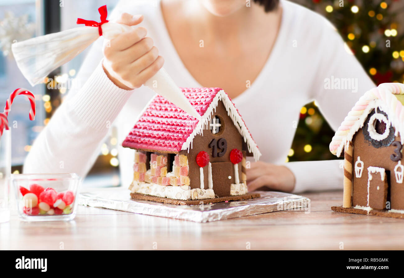 woman making gingerbread houses on christmas Stock Photo - Alamy