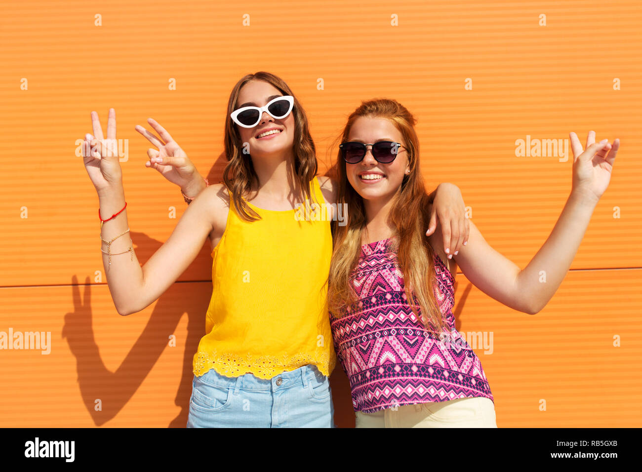 smiling teenage girls showing peace in summer Stock Photo - Alamy