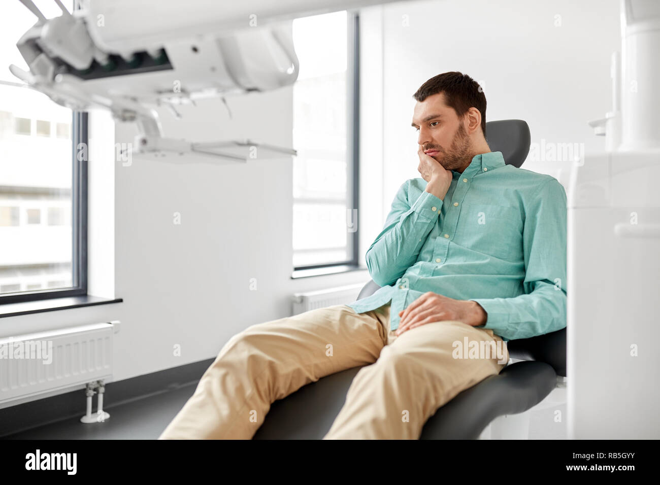 patient suffering from toothache at dental clinic Stock Photo - Alamy