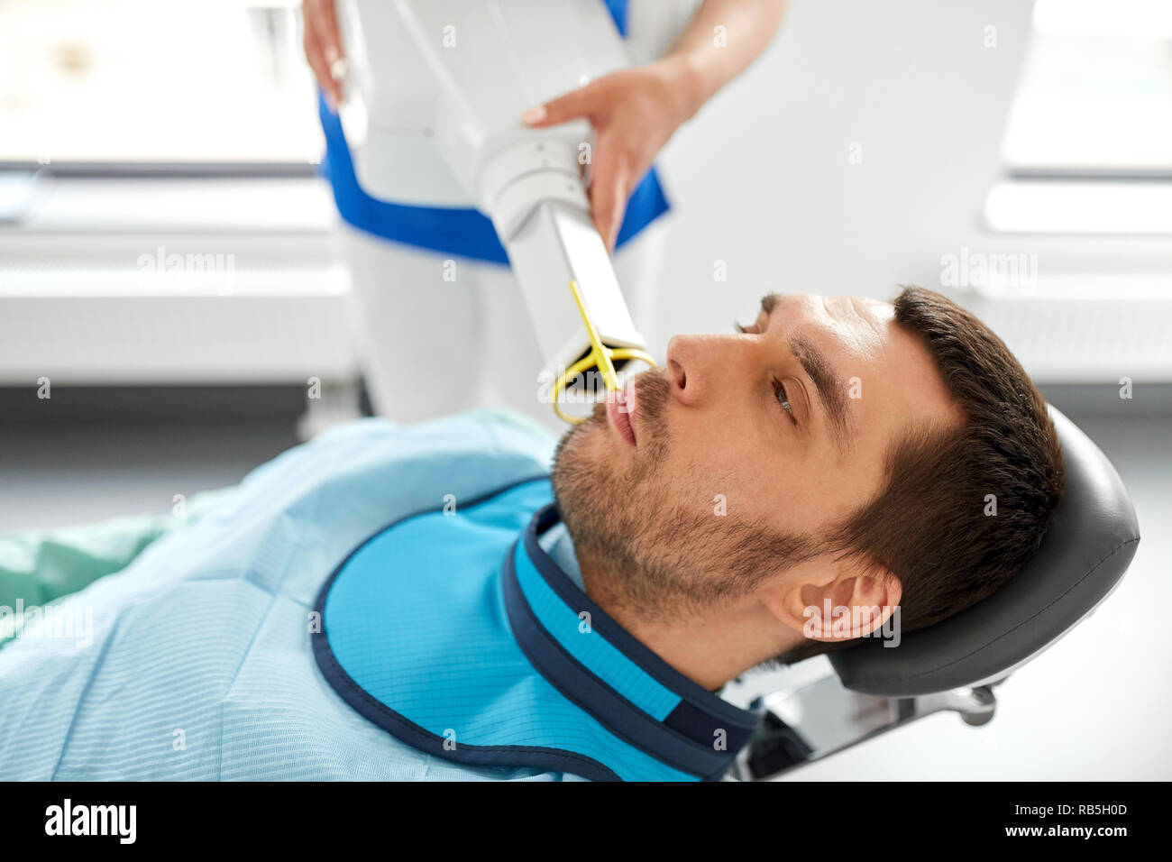 dentist making dental x-ray of patient teeth Stock Photo - Alamy