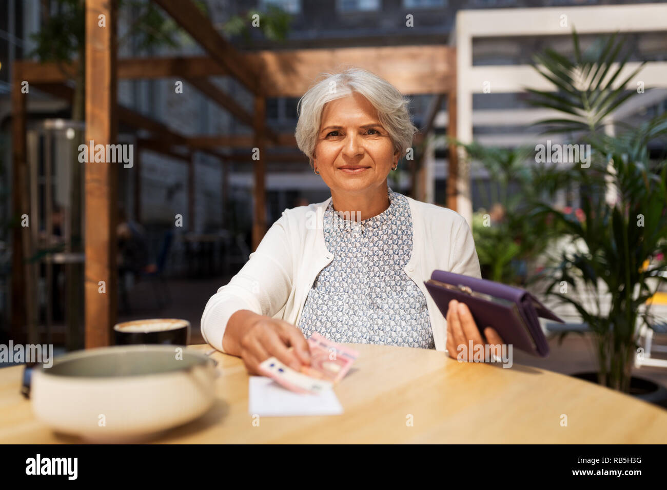 Mature adult female paying bill hi-res stock photography and images - Alamy