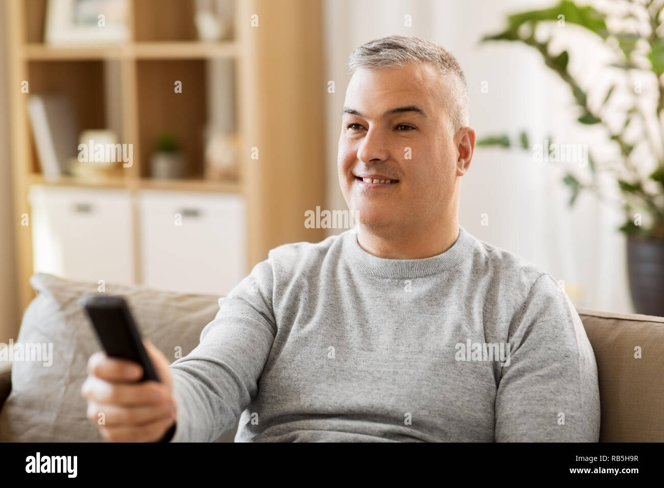 Middle aged man watching tv hi-res stock photography and images - Alamy