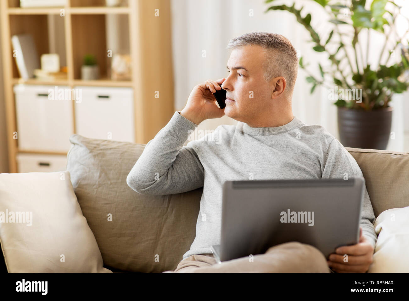 Man browsing smartphone sitting on hi-res stock photography and images ...