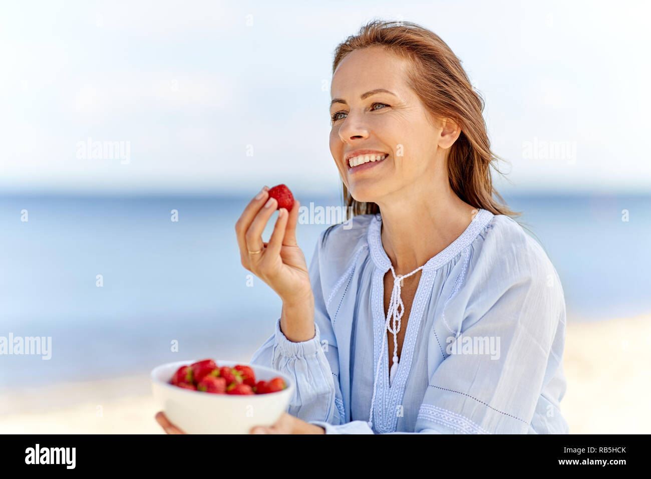 Woman beach eating fruit not fruits hi-res stock photography and images ...