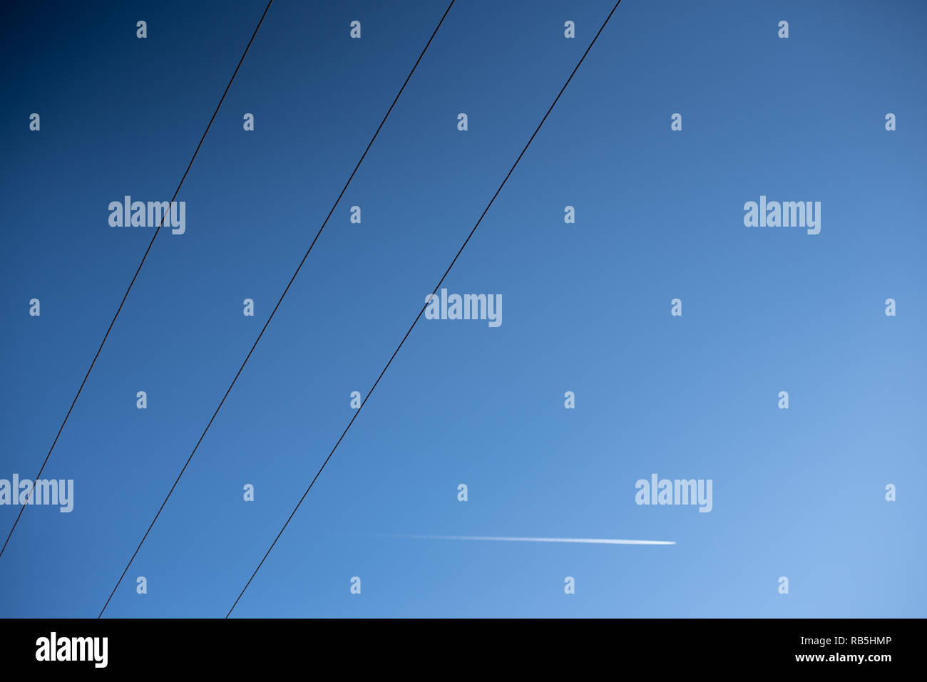 Sky background with electric cables crossing the image Stock Photo - Alamy