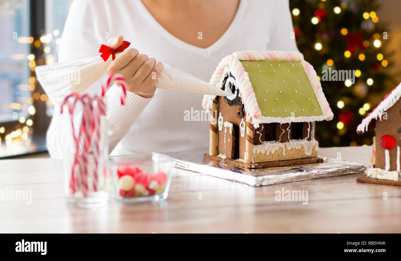 woman making gingerbread houses on christmas Stock Photo - Alamy
