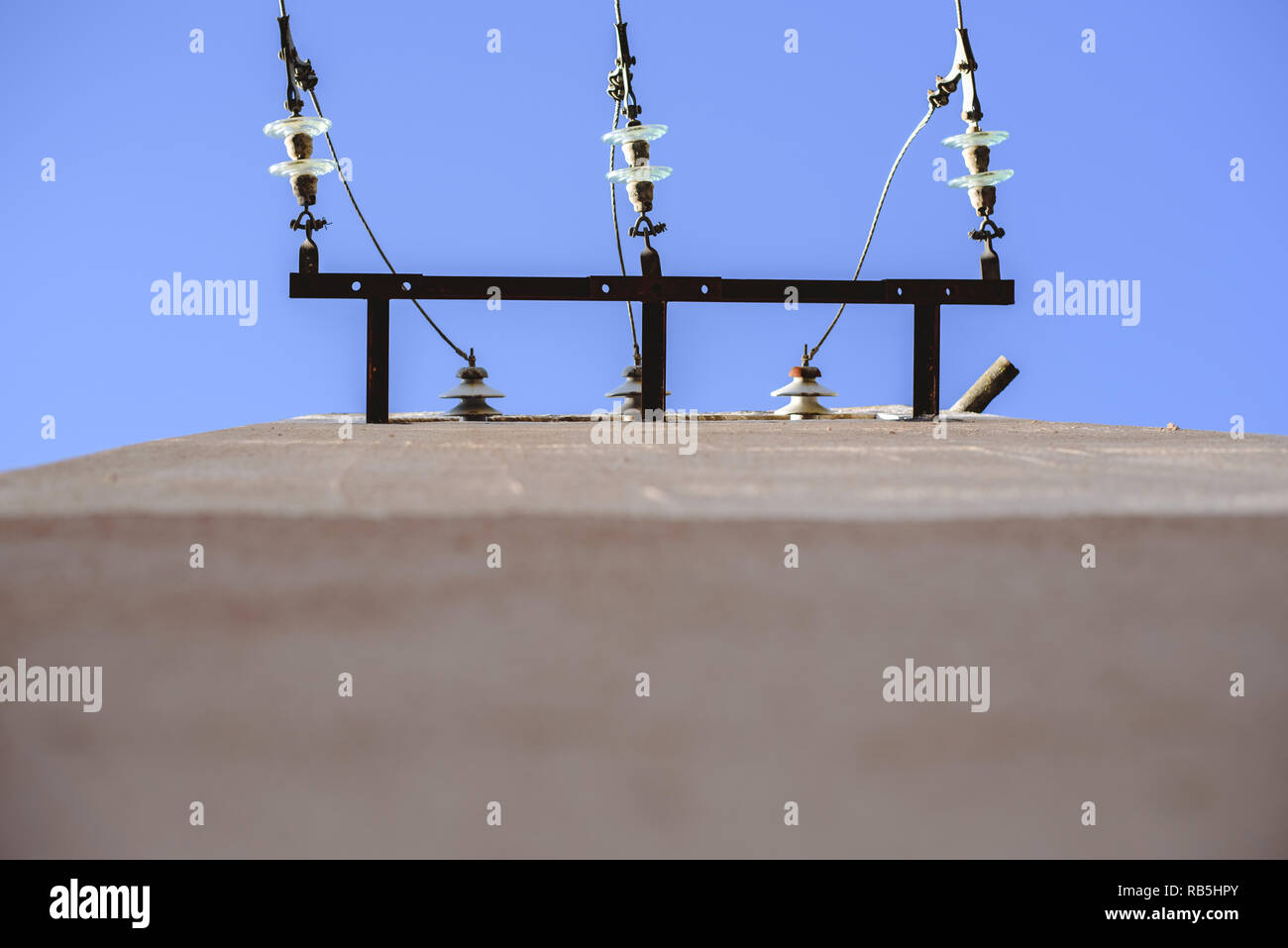 Electric cables seen from below with blue sky background Stock Photo ...