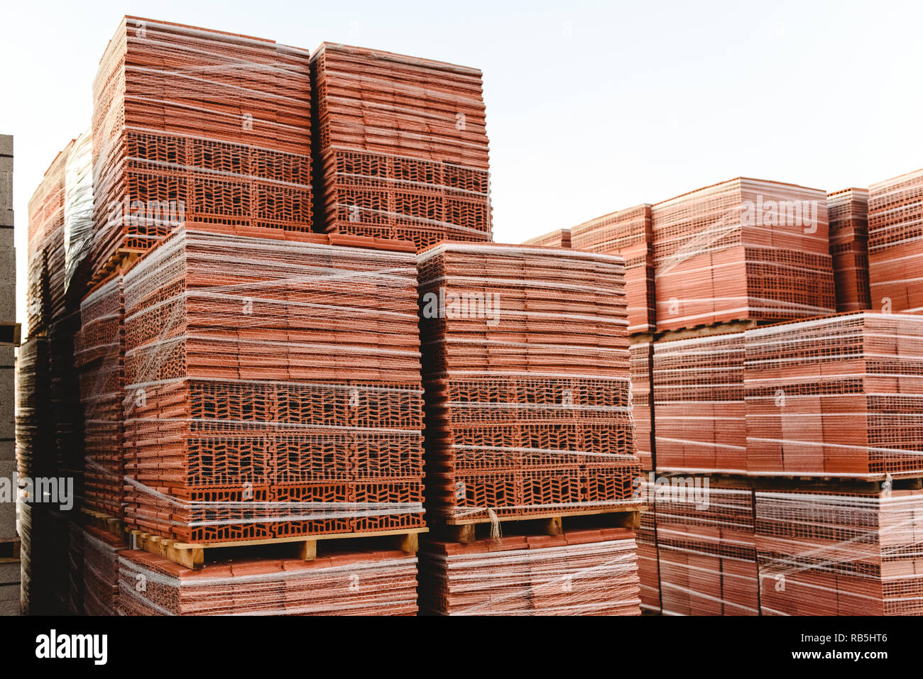 Brick pallets ready to build buildings by bricklayers Stock Photo - Alamy