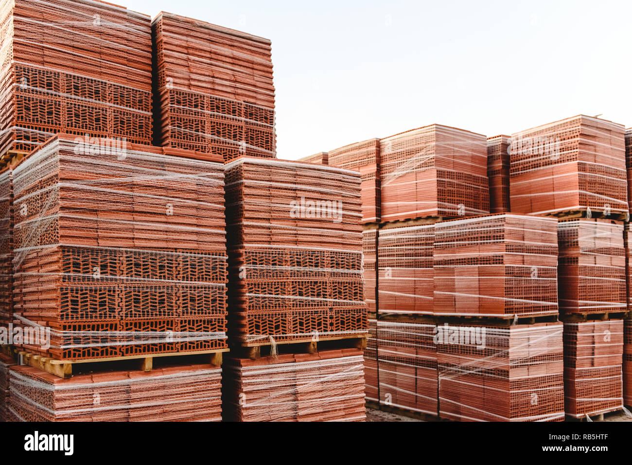 Brick pallets ready to build buildings by bricklayers Stock Photo - Alamy