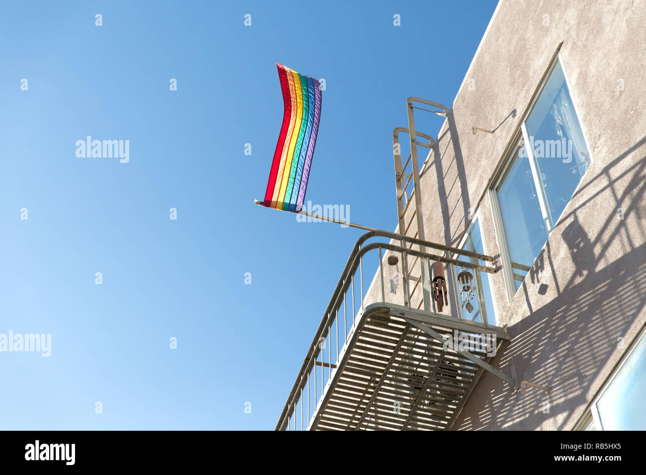 gay pride rainbow flag waving on building balcony Stock Photo - Alamy