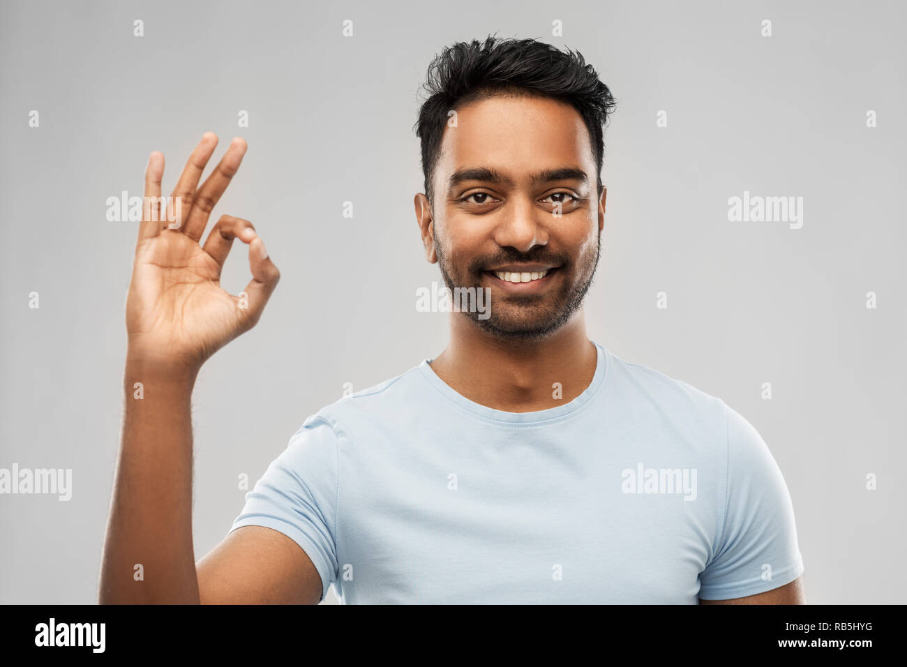 happy indian man in t-shirt showing ok hand sign Stock Photo - Alamy