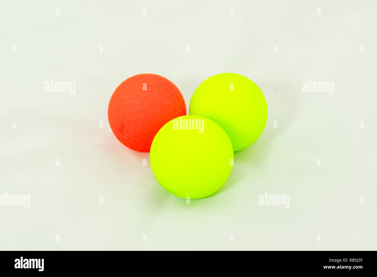 three colored golf balls Stock Photo - Alamy