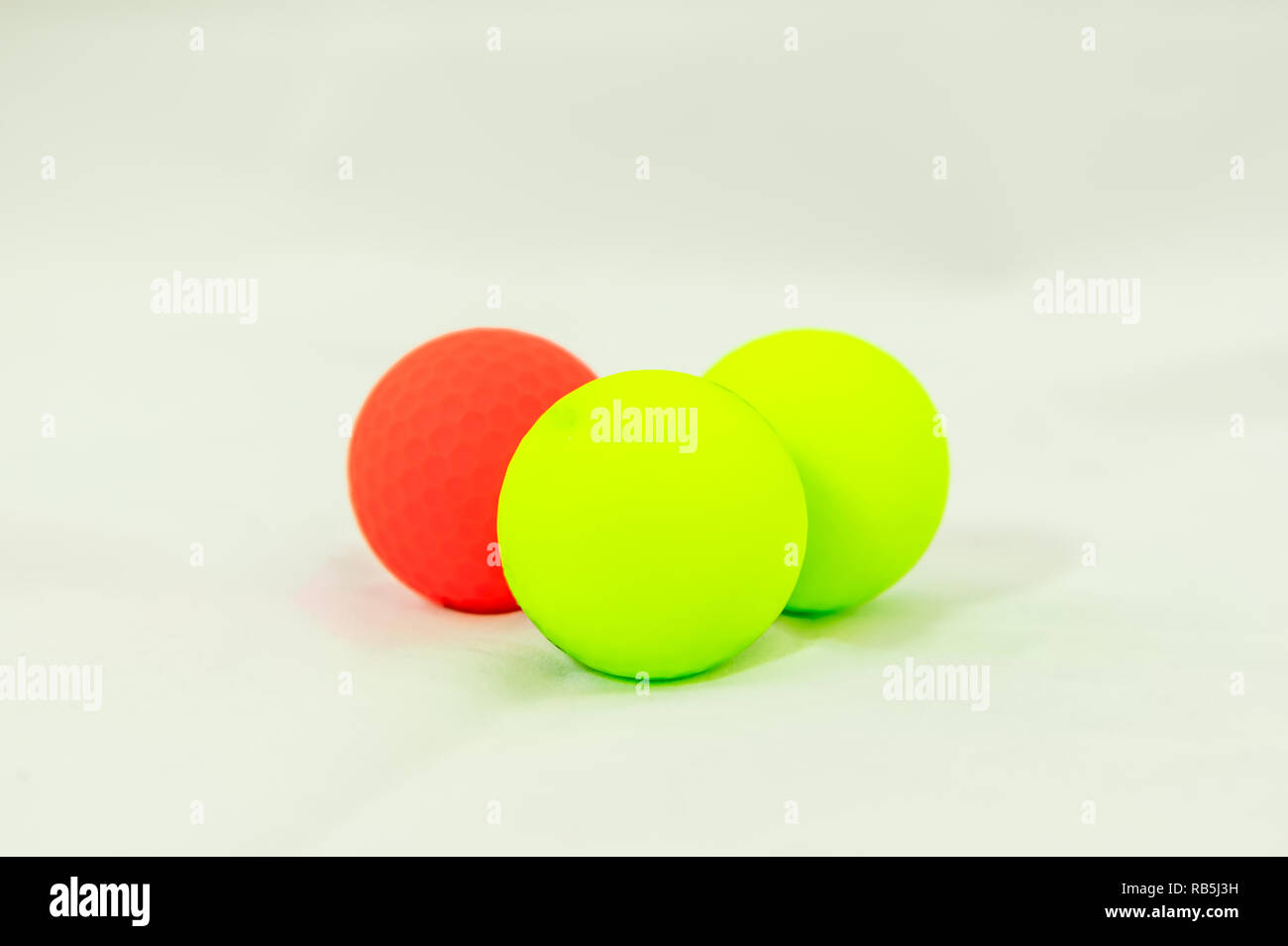 three colored golf balls Stock Photo - Alamy
