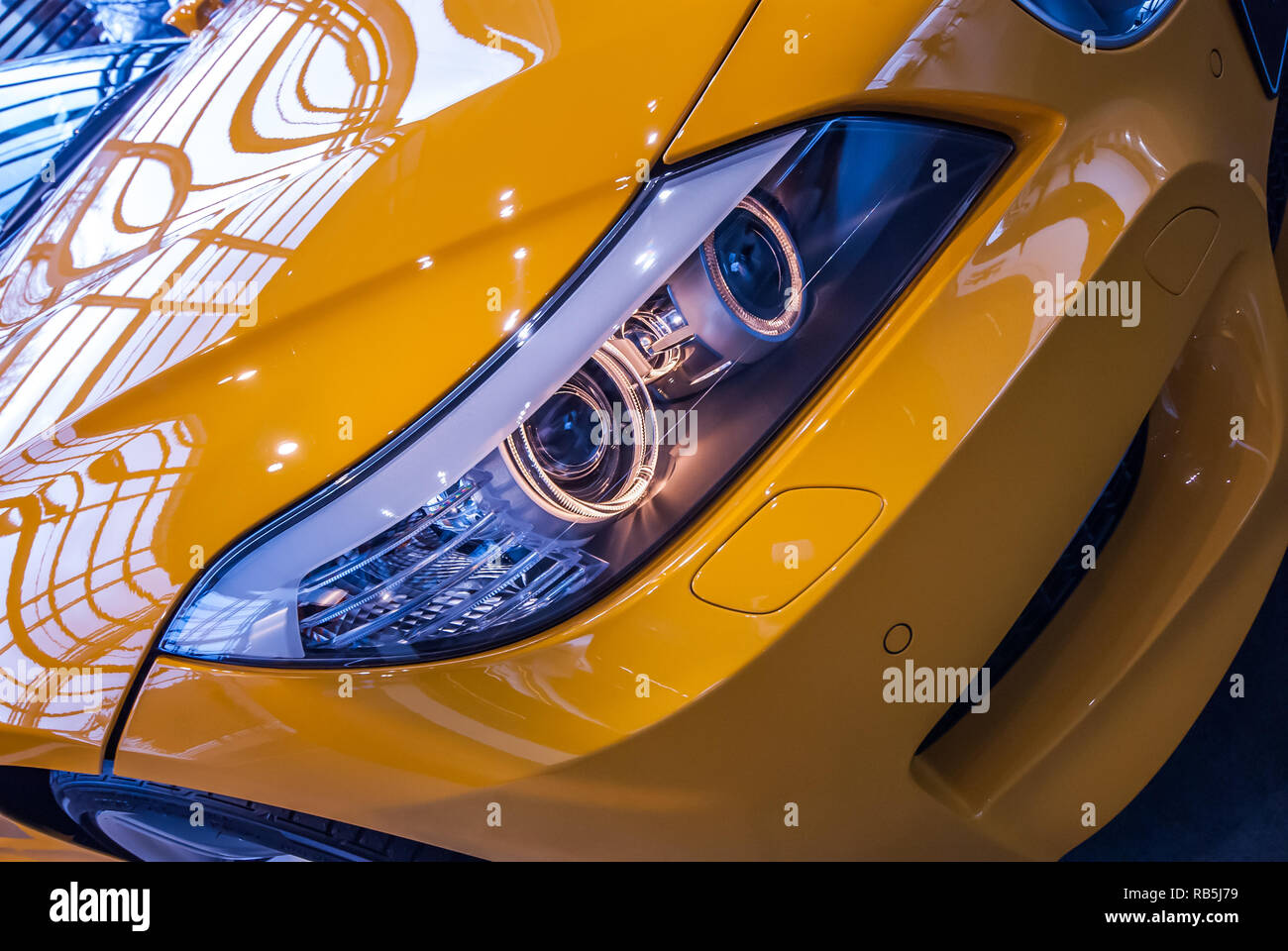 Yellow sport car closeup front headlight Stock Photo - Alamy