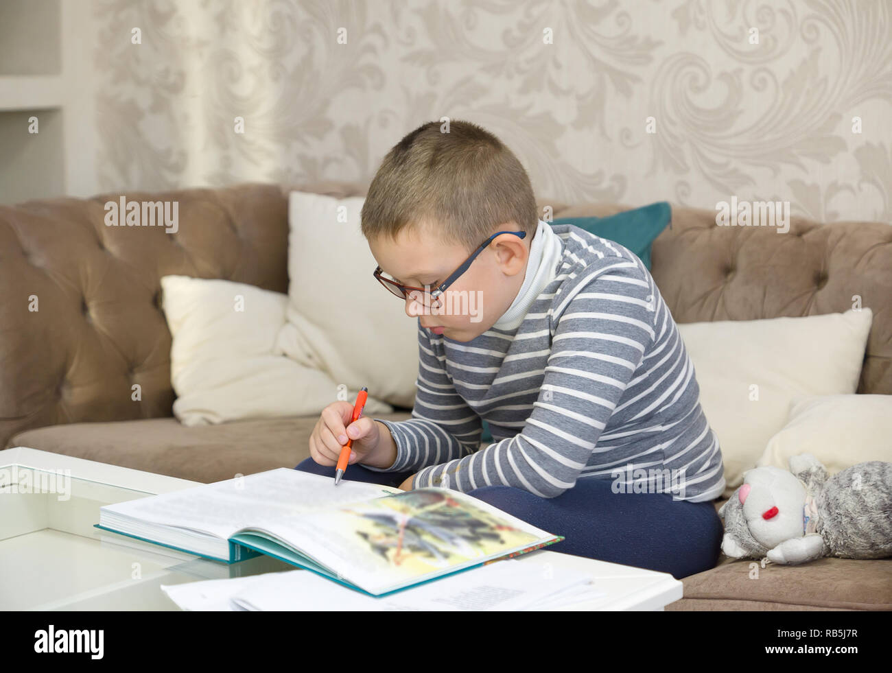 young boy learns to read a big book Stock Photo - Alamy
