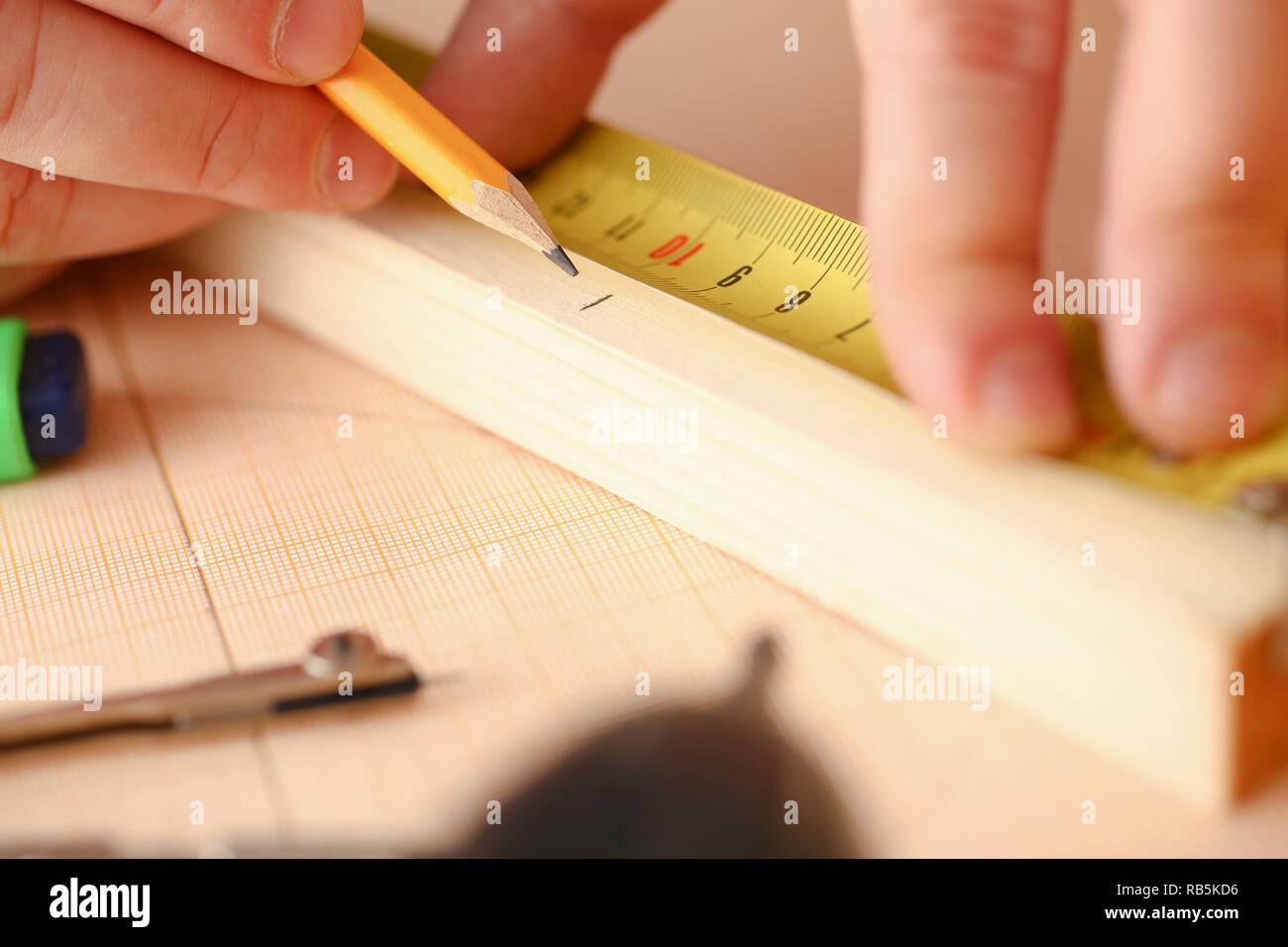 Arms of worker measuring wooden bar Stock Photo - Alamy