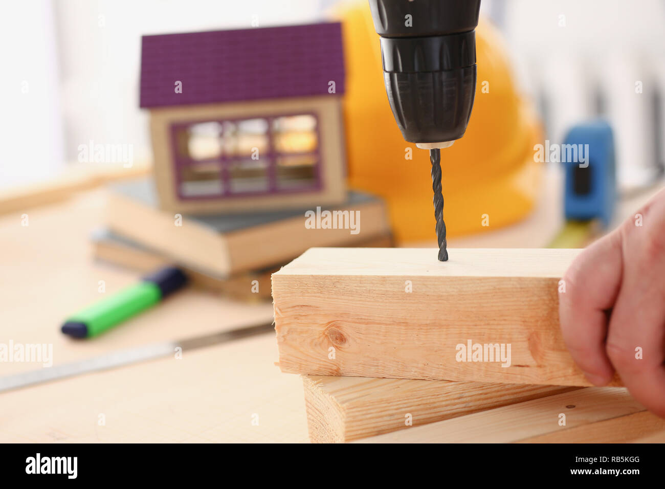Arms of worker using electric drill Stock Photo - Alamy