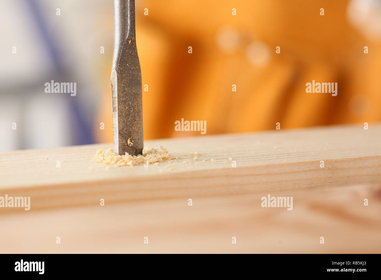 Flat drill bit make hole in wooden bar Stock Photo - Alamy