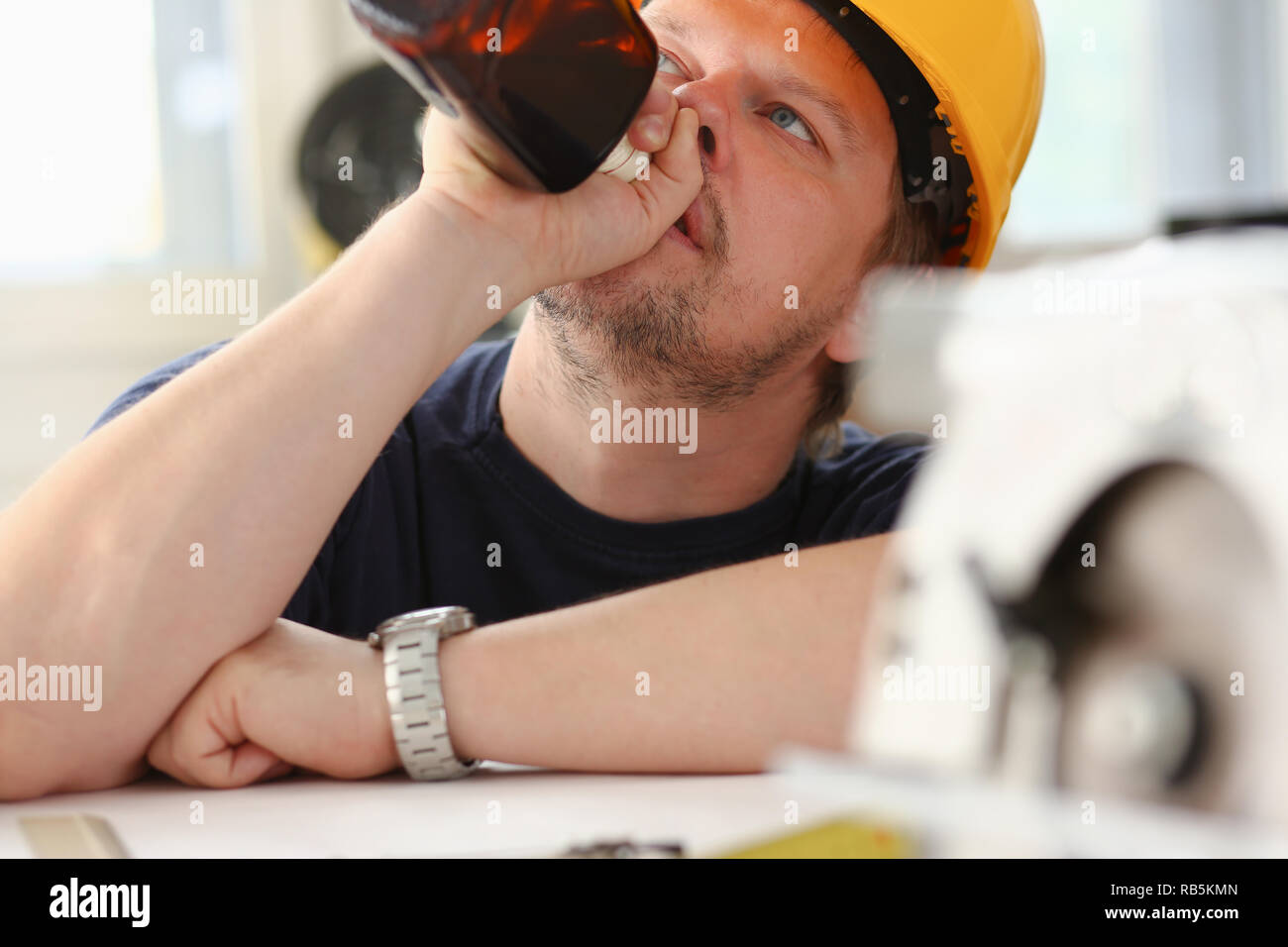 Arm of drunken worker in yellow helmet Stock Photo - Alamy
