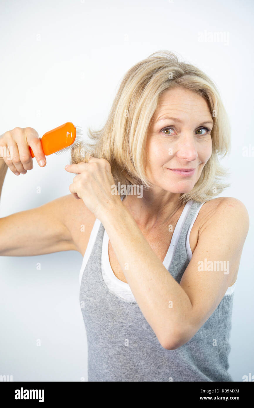 Woman looking at her split ends Stock Photo - Alamy