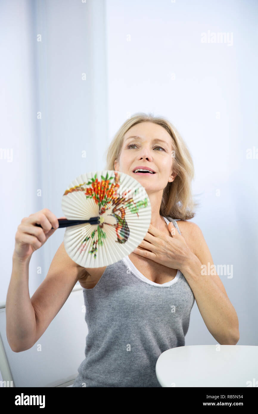 Woman fanning herself hi-res stock photography and images - Alamy