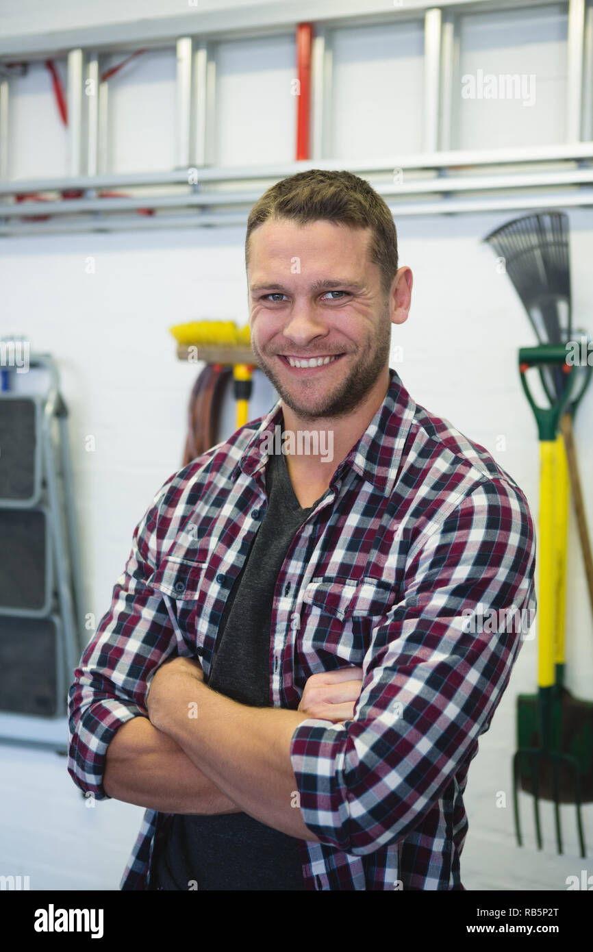 Male carpenter standing with arms crossed Stock Photo - Alamy