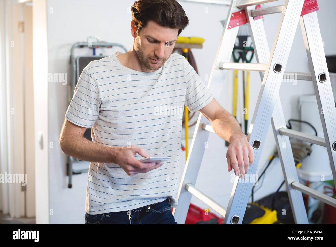 Male painter using mobile phone Stock Photo - Alamy