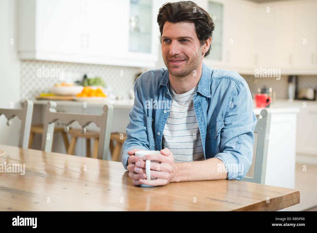 Man having coffee in kitchen at home Stock Photo - Alamy