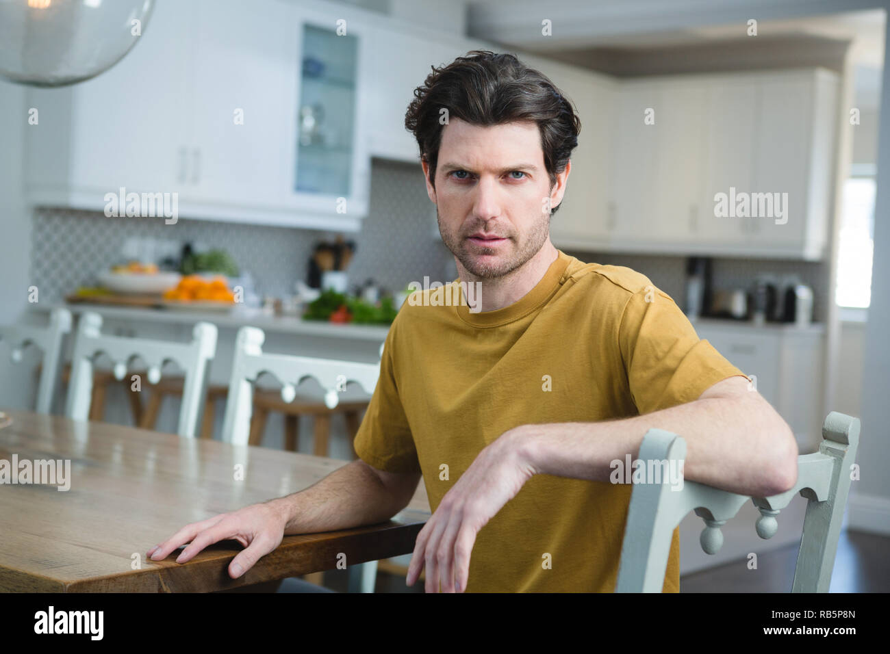 Young man sitting at home Stock Photo - Alamy