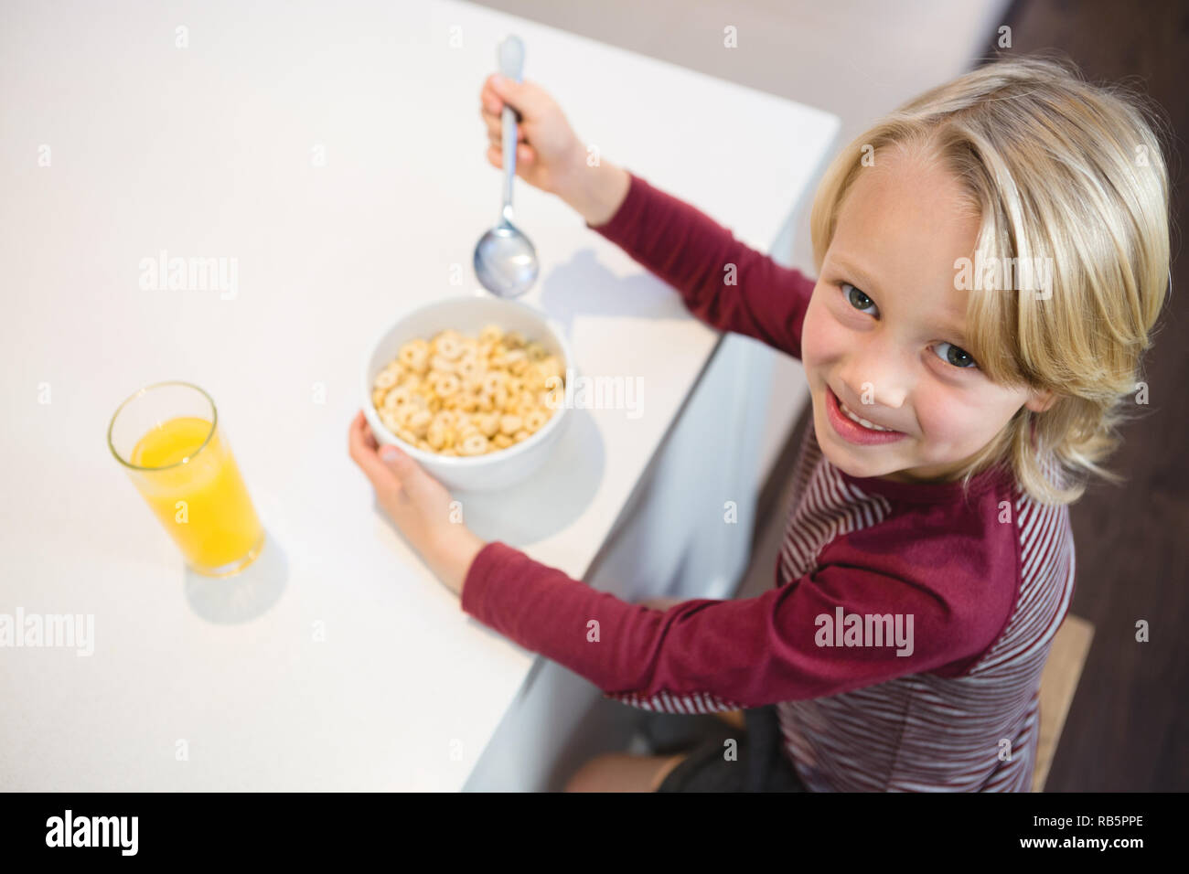 Boy having his breakfast at home Stock Photo - Alamy