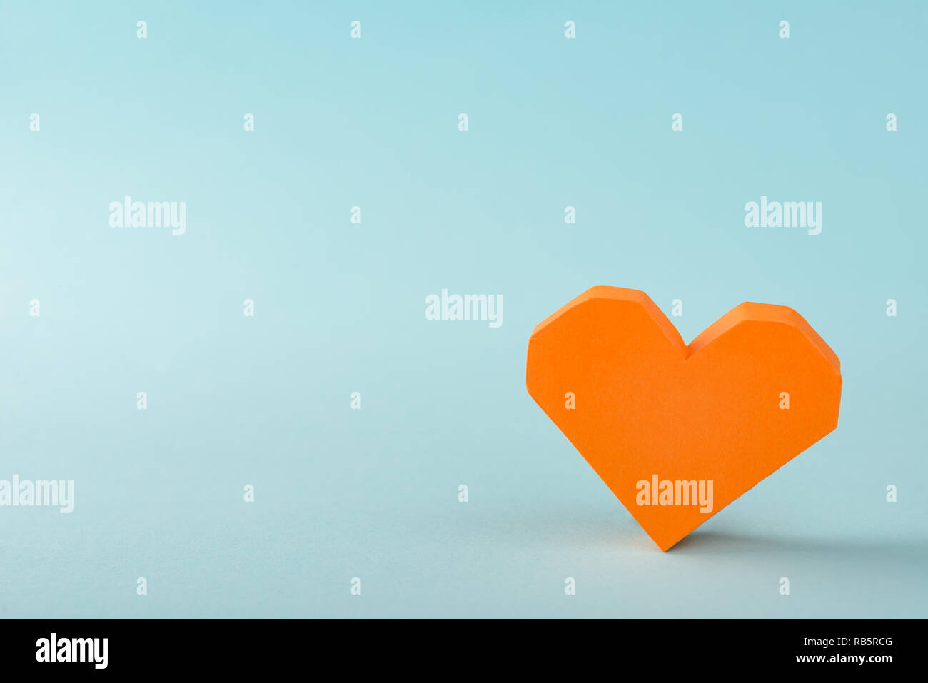 Orange 3D paper heart Stock Photo - Alamy