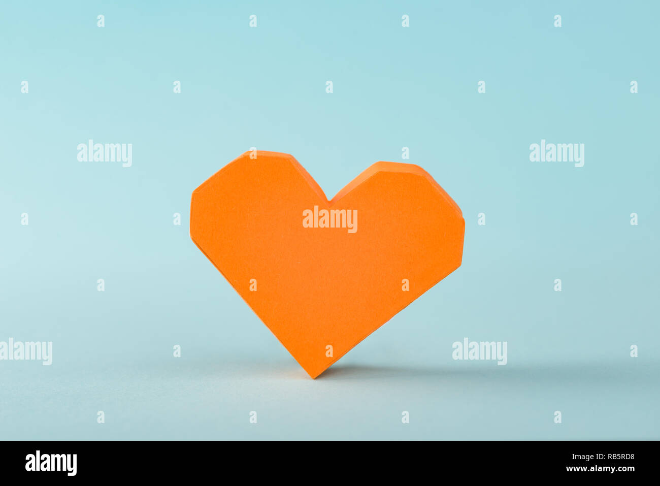 Orange 3D paper heart Stock Photo - Alamy