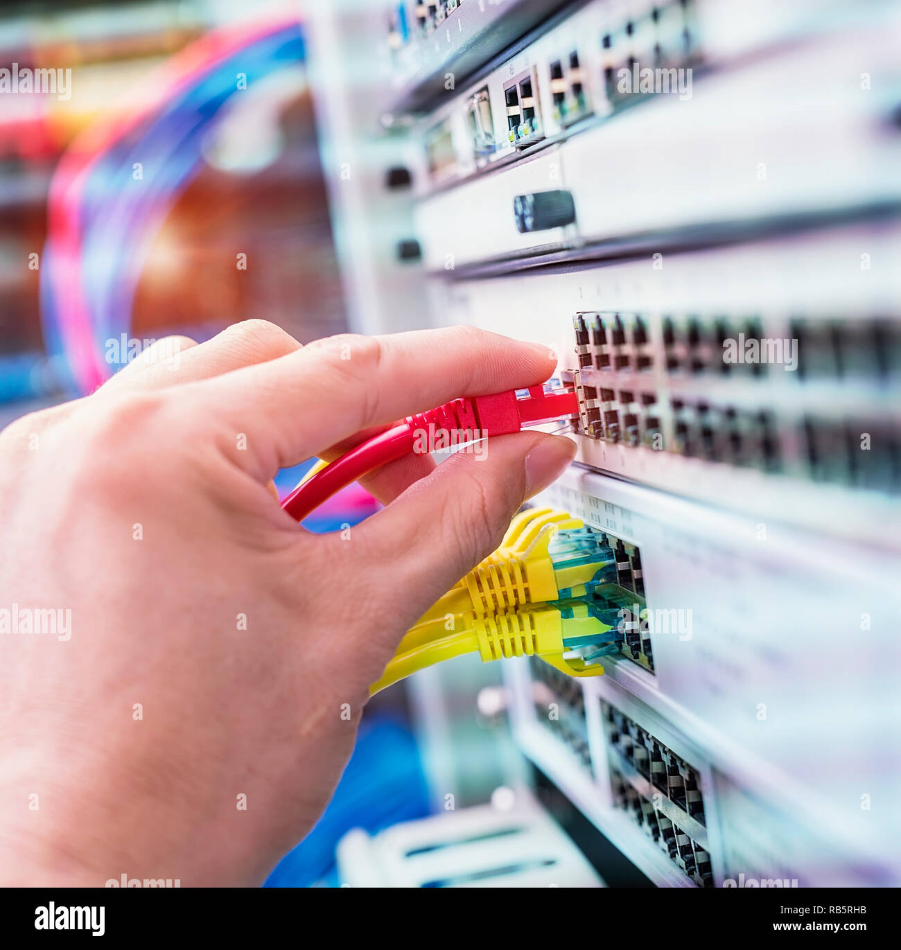 hand with network cables connected to servers in datacenter Stock Photo ...