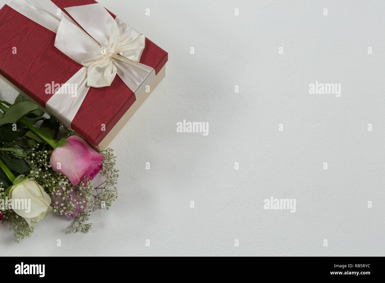Flower bouquet and gift on white background Stock Photo - Alamy