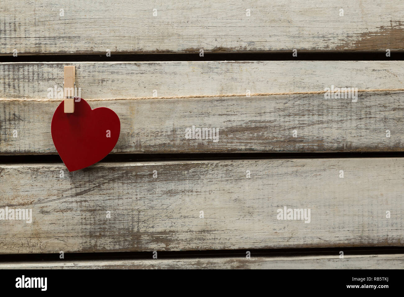 Heart shape decoration hanging on thread Stock Photo - Alamy