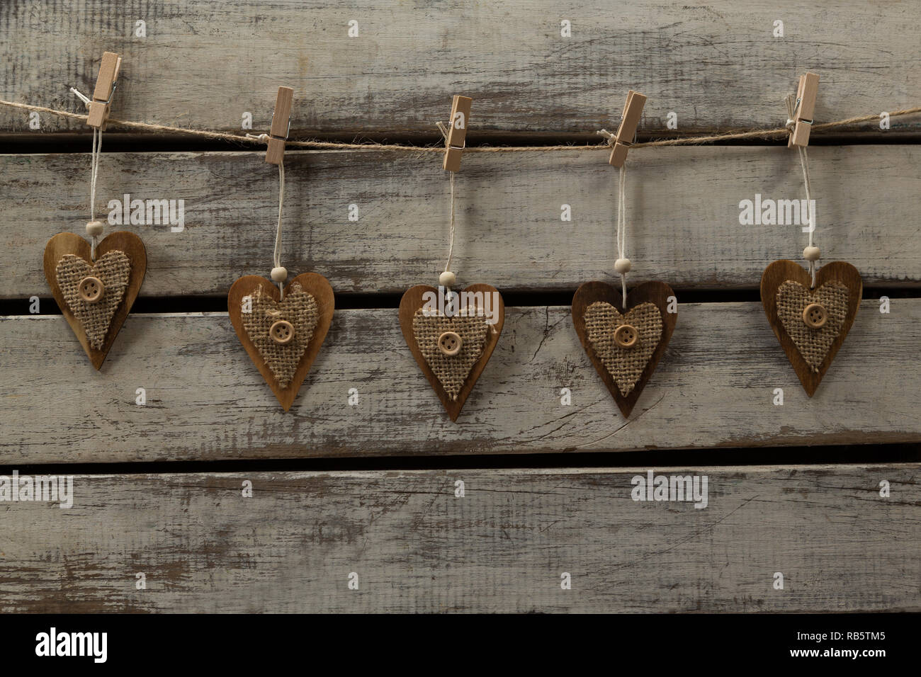 Heart shape decorations hanging on thread Stock Photo - Alamy