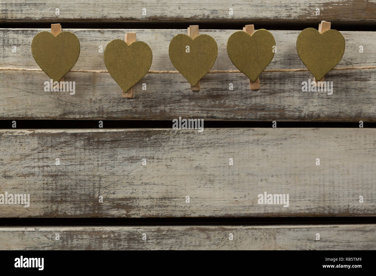 Heart shape decorations hanging on thread Stock Photo - Alamy