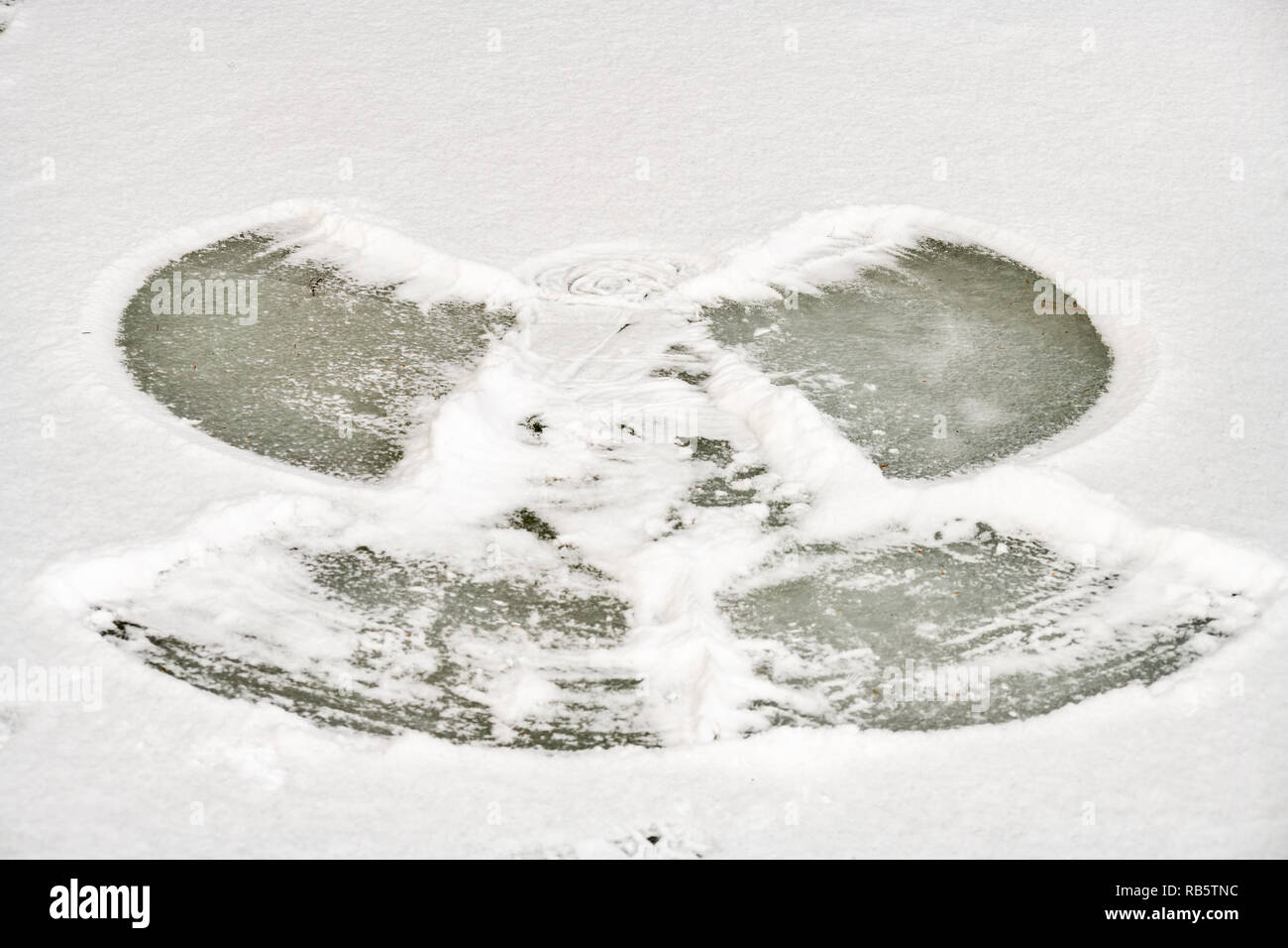 Angel figure in the snow made by a kid in a frozen lake one cold winter ...