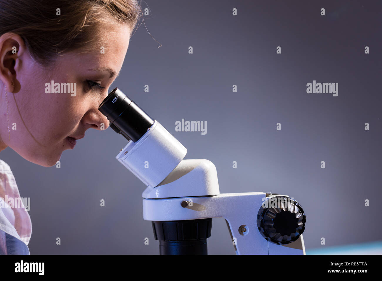 Young scientist using a microscope hi-res stock photography and images ...