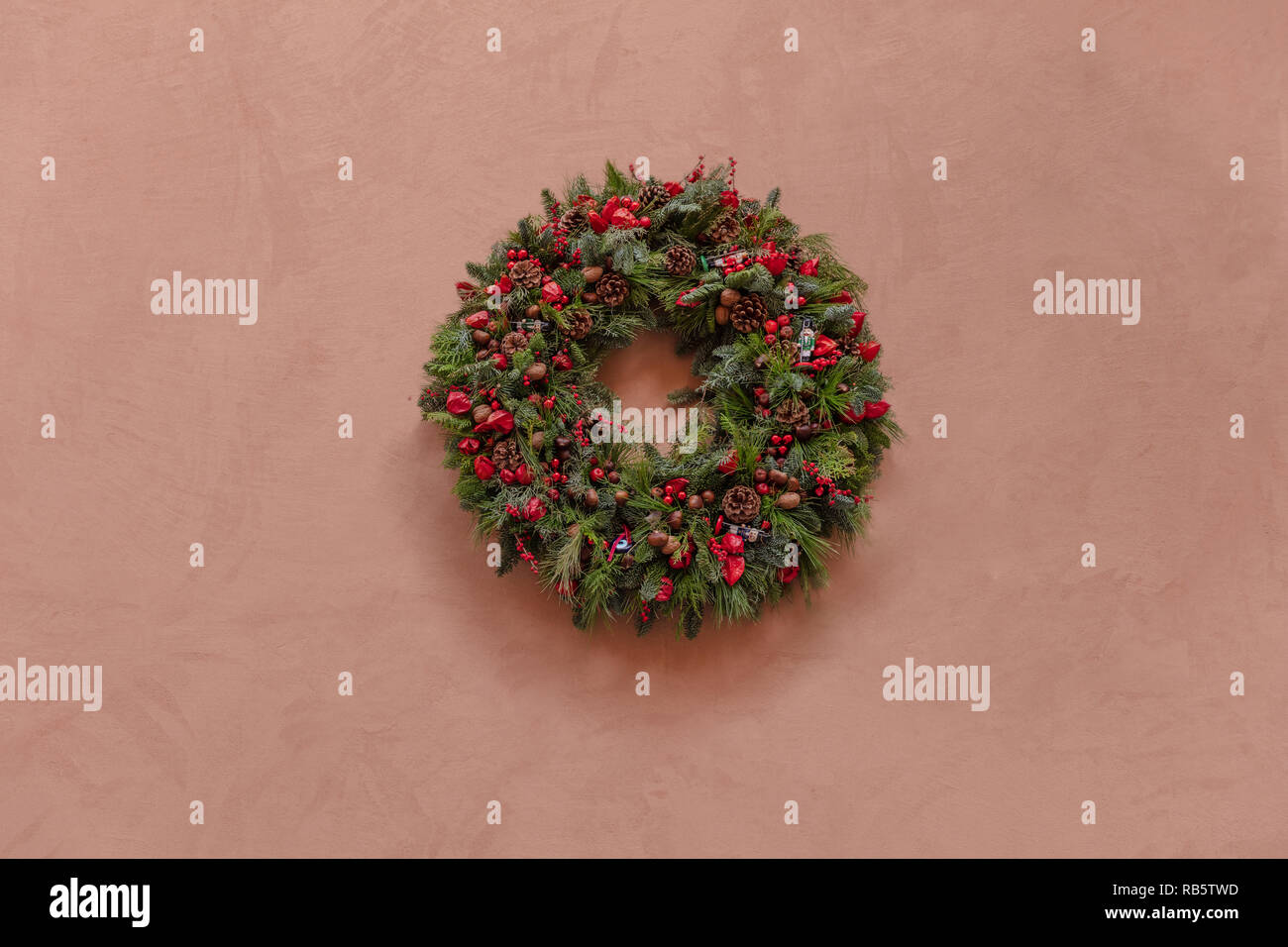 Christmas wall decoration. Christmas wreath on a stucco painted wall ... Christmas wall decoration. Christmas wreath on a stucco painted wall ...