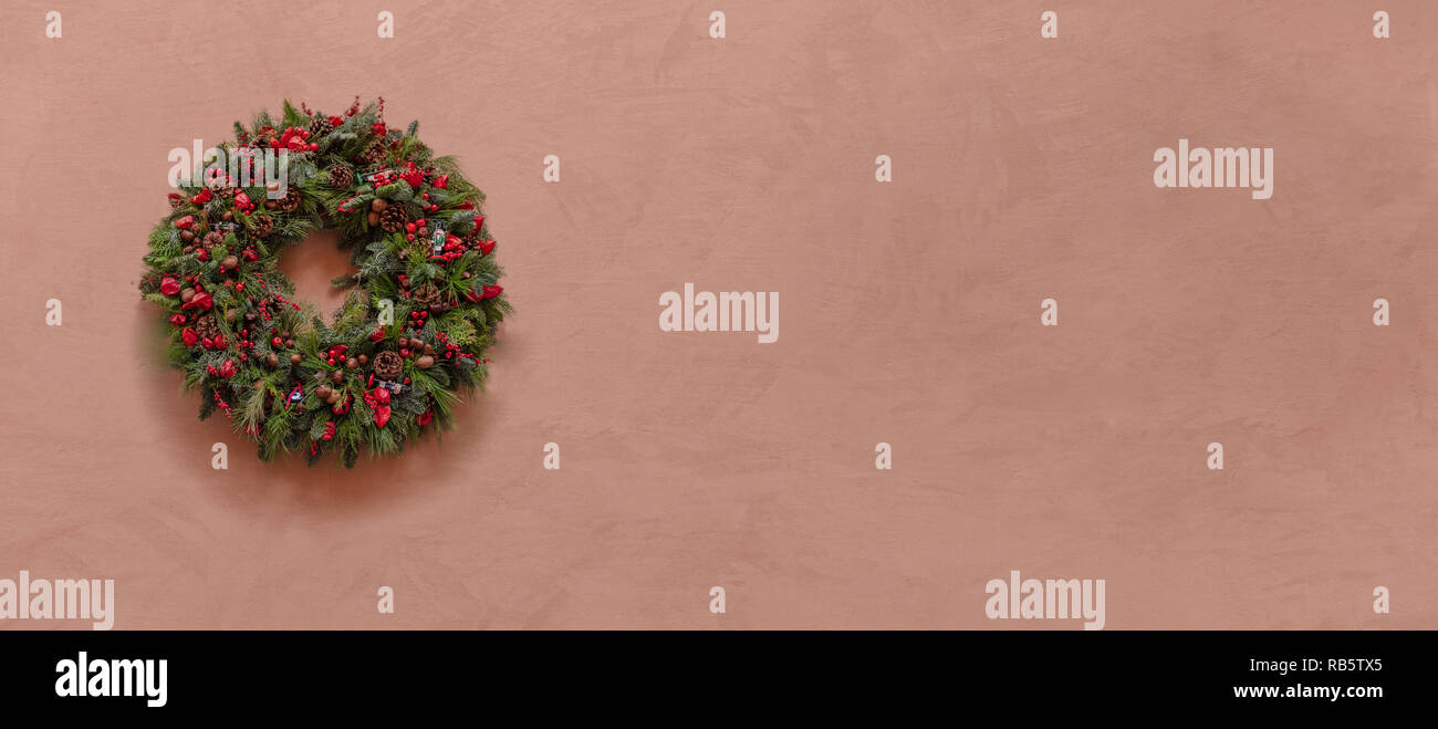 Christmas wall decoration. Christmas wreath on a stucco painted wall ... Christmas wall decoration. Christmas wreath on a stucco painted wall ...