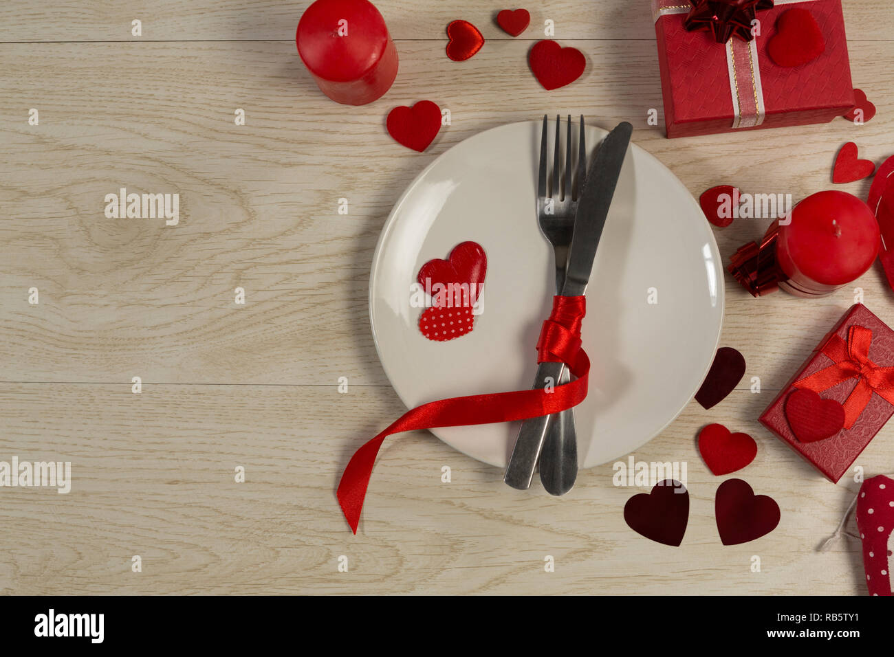 Gift boxes and heart shape decorations with cutlery Stock Photo - Alamy