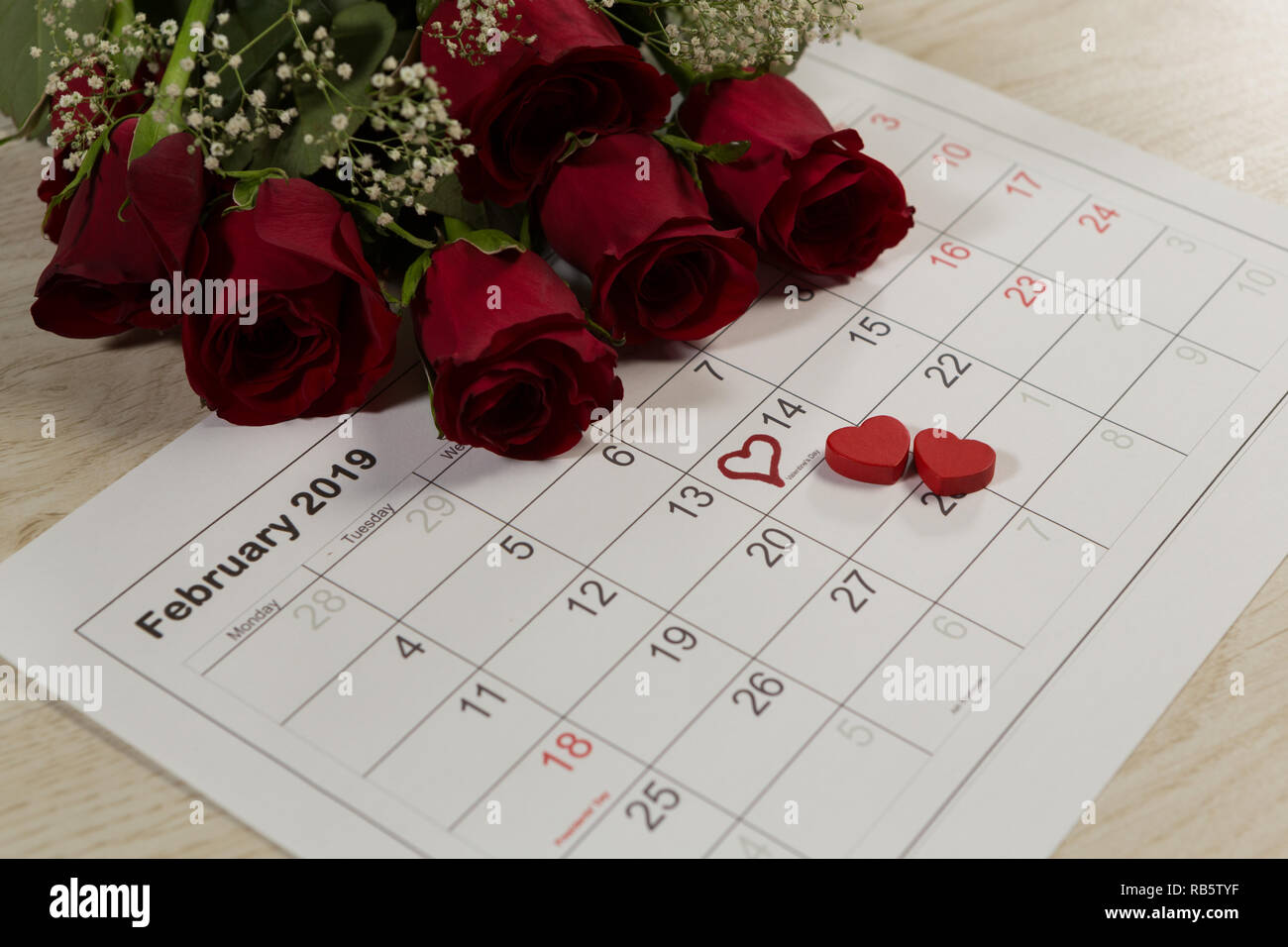 Rose bouquet with heart shape decorations on February calendar Stock ...