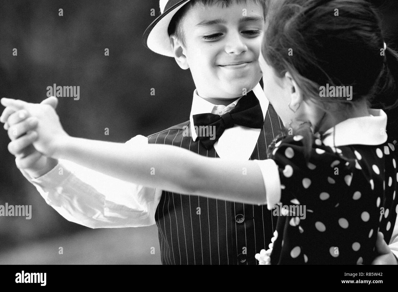 Lovely young couple dancing and having fun. Focus on the boy face. More ...