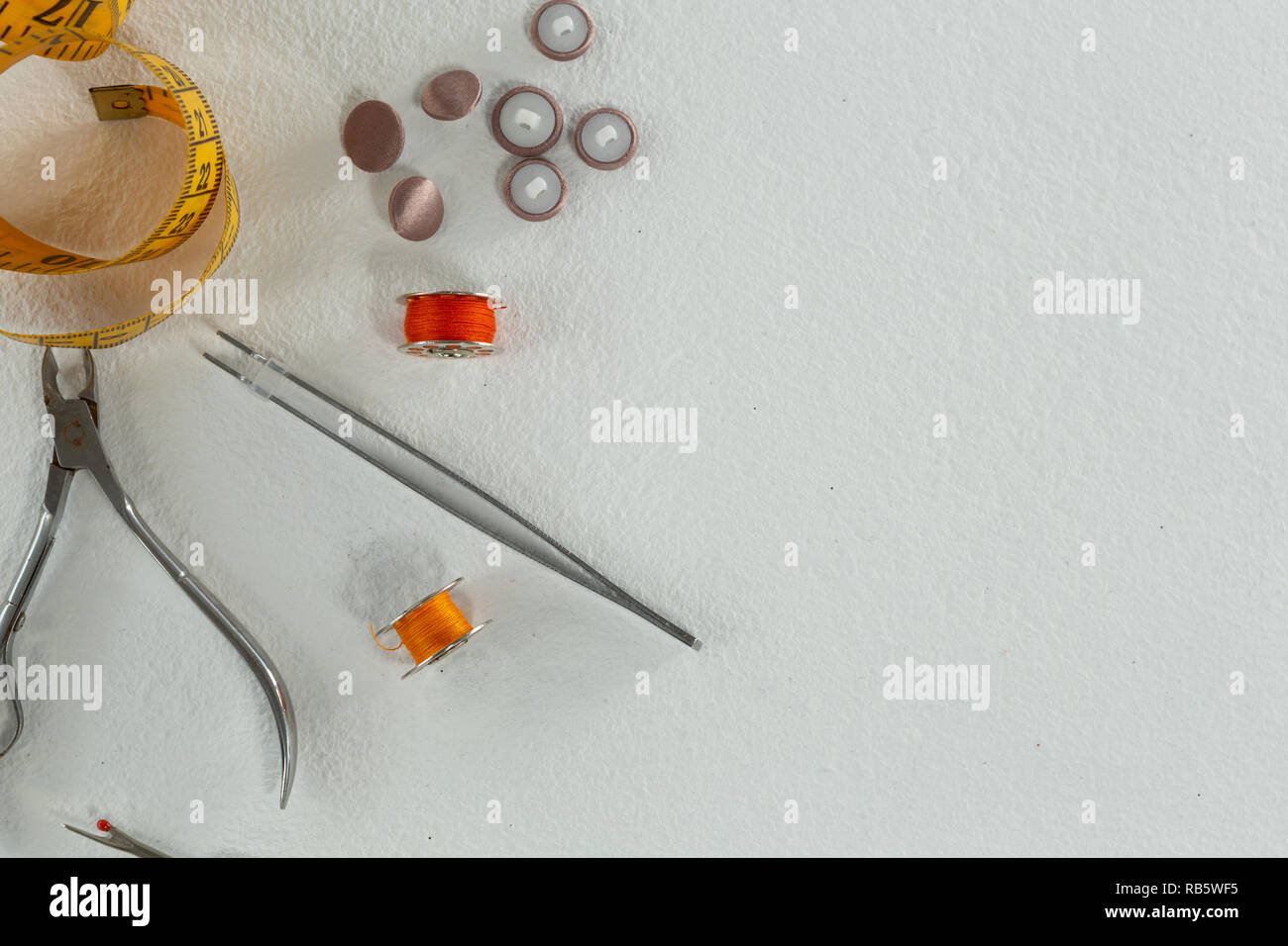 Thread rolls and various tools on white background Stock Photo - Alamy