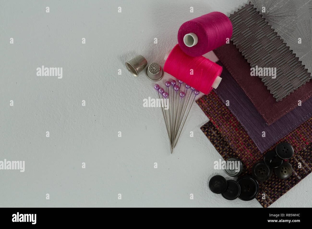 Thread rolls and tools on white background Stock Photo - Alamy